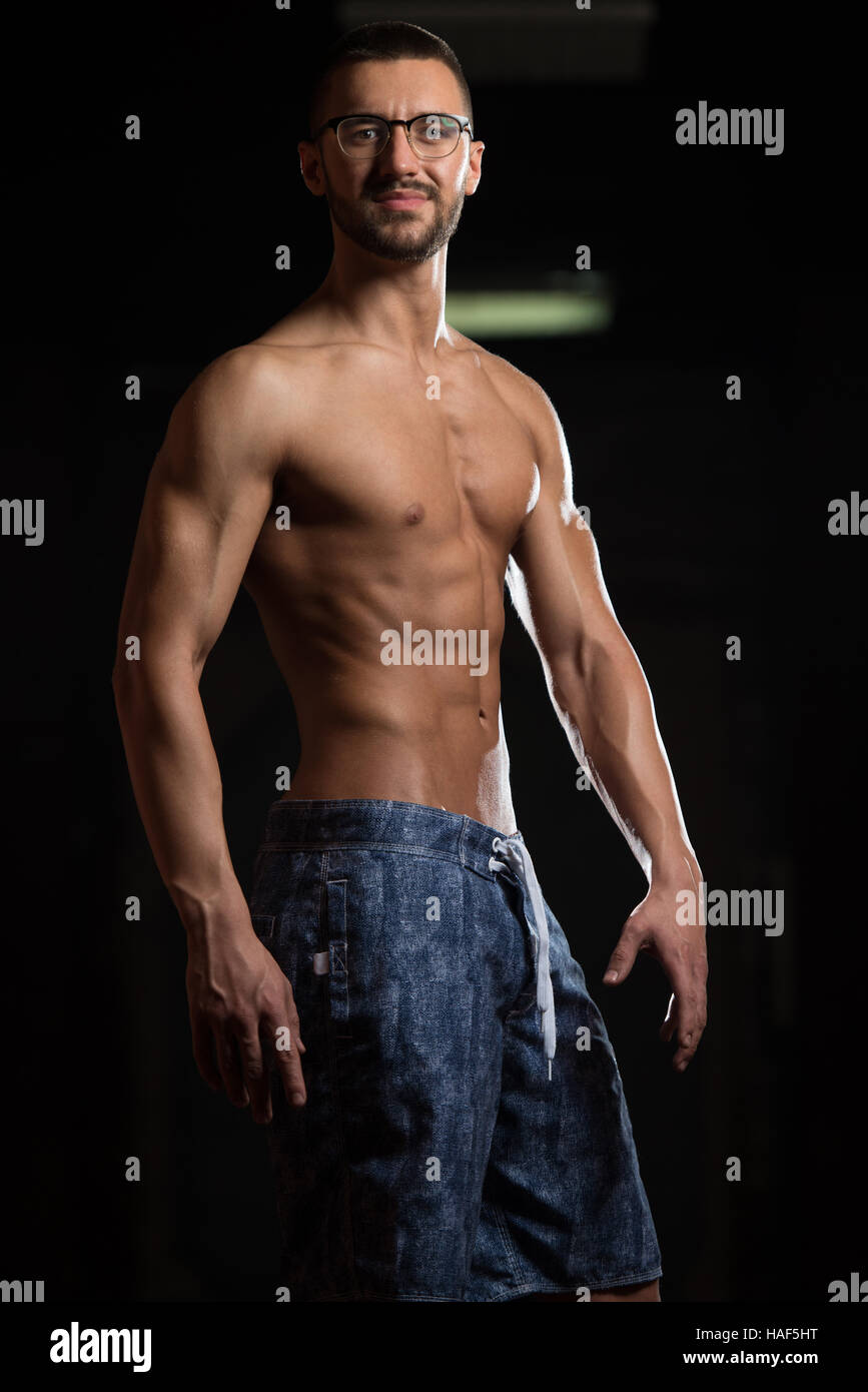 Portrait Of A Young Physically Fit Nerd Man Showing His Well Trained ...