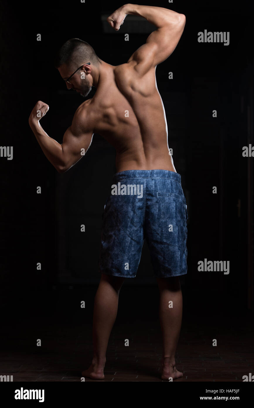 Portrait Of A Young Physically Fit Nerd Man Showing His Well Trained ...