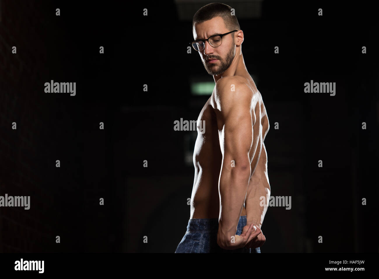 Portrait Of A Young Physically Fit Nerd Man Showing His Well Trained ...