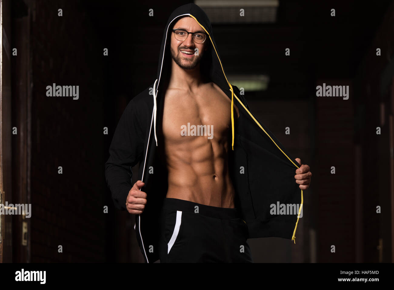 Portrait Of A Young Physically Fit Nerd Man Showing His Well Trained ...