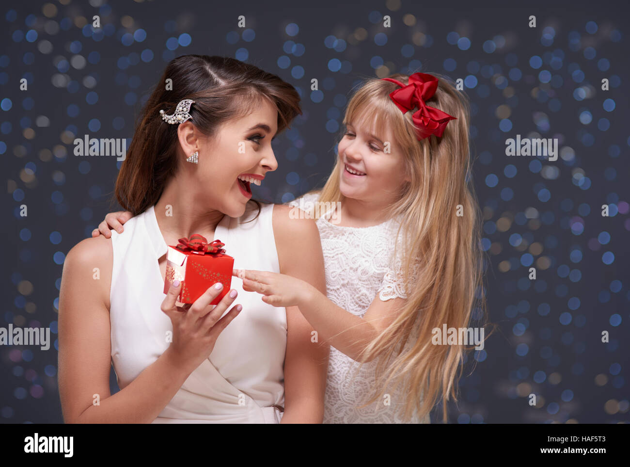 Girl giving present to her mommy Stock Photo - Alamy