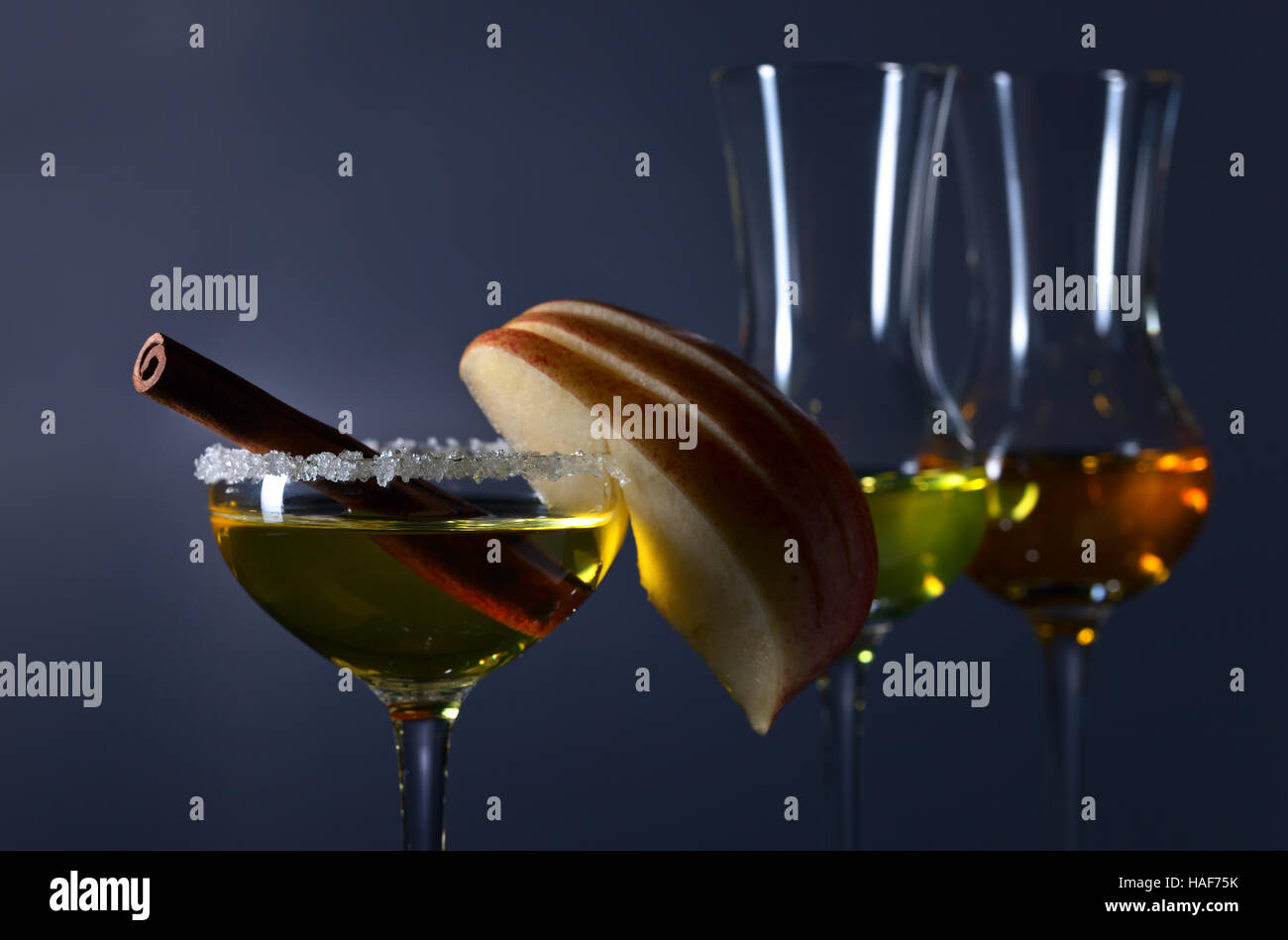 sweet liquor with apple and cinnamon stick Stock Photo - Alamy