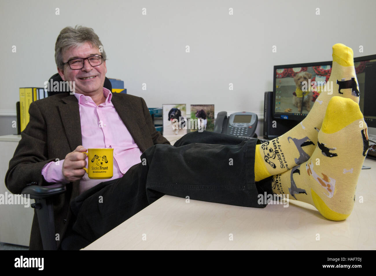 EDITORIAL USE ONLY Adrian Burder, CEO of the Dogs Trust, models a pair ...