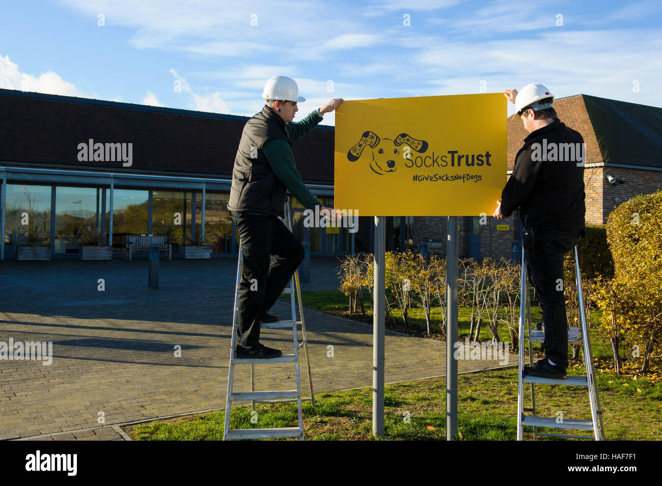 EDITORIAL USE ONLY Two workmen change the welcome sign at the Dogs ...