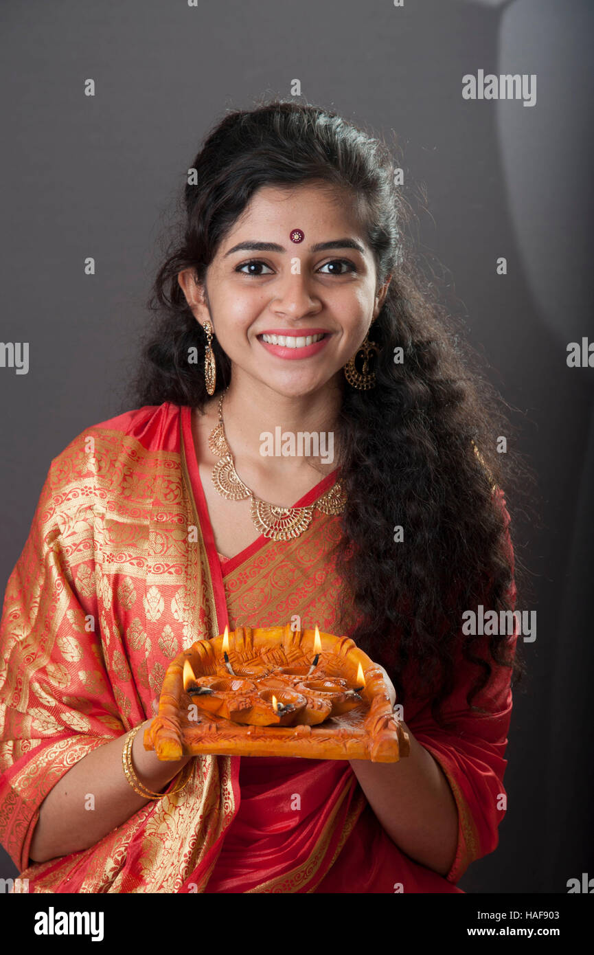 Woman holding diya hi-res stock photography and images - Alamy