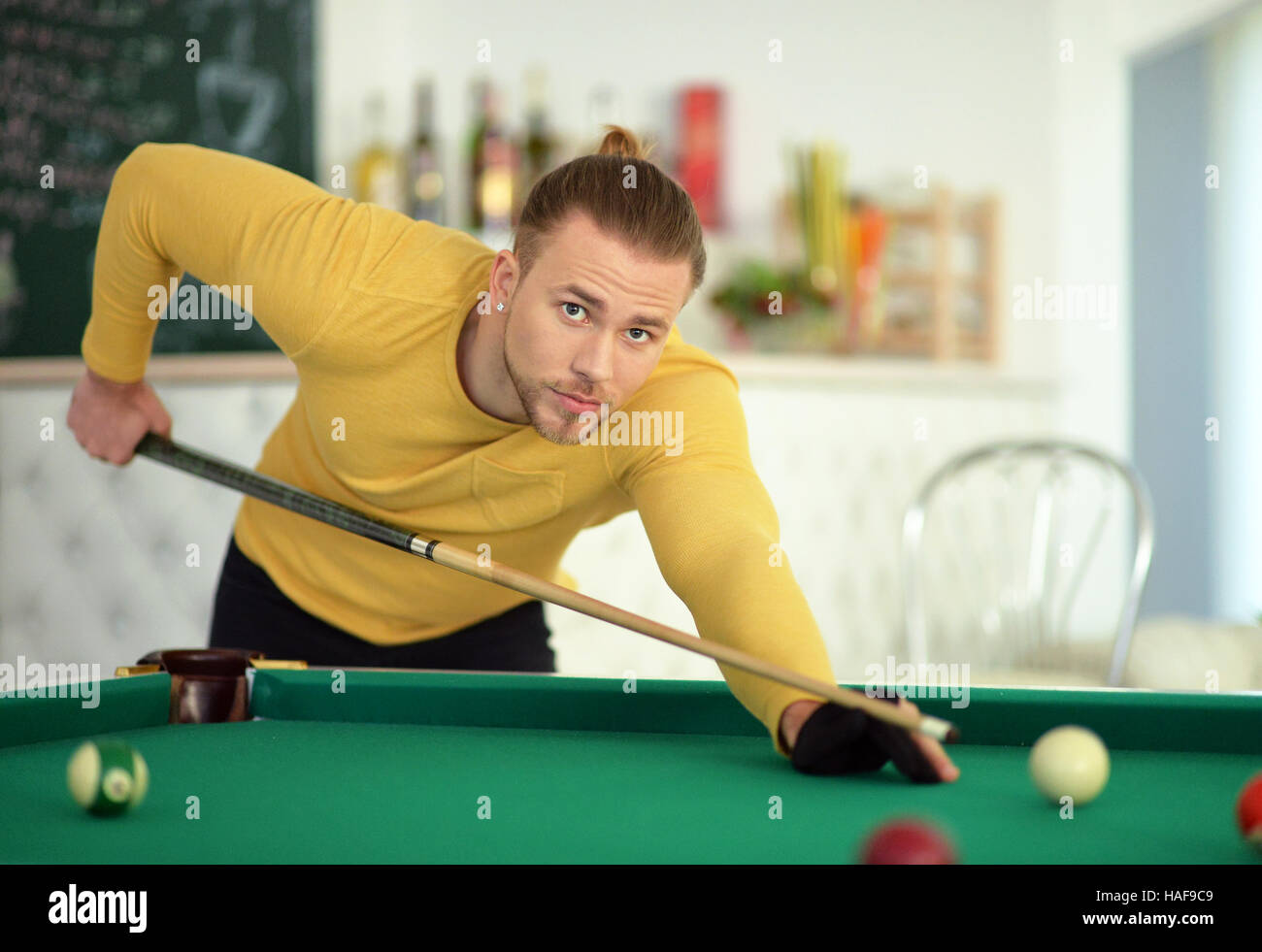 Man playing billiards Stock Photo - Alamy