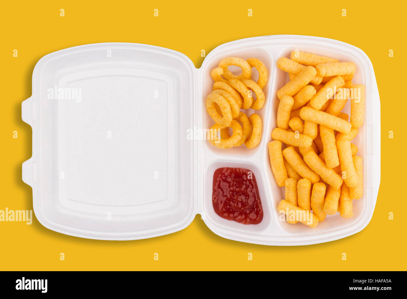 top view of junk food ingredients and a dip of ketchup in a white take ...