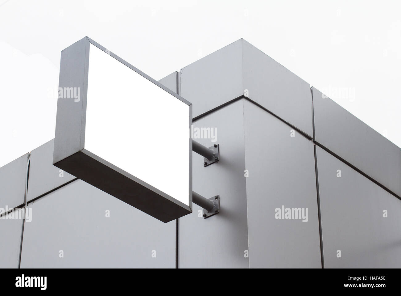 Horizontal front view of empty square white signage on a building with ...