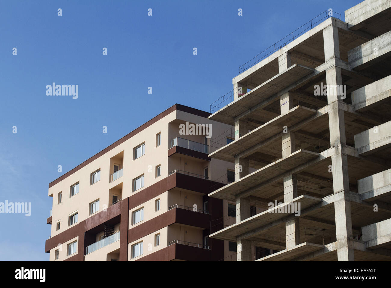 Residential construction site with a finished building and one in ...