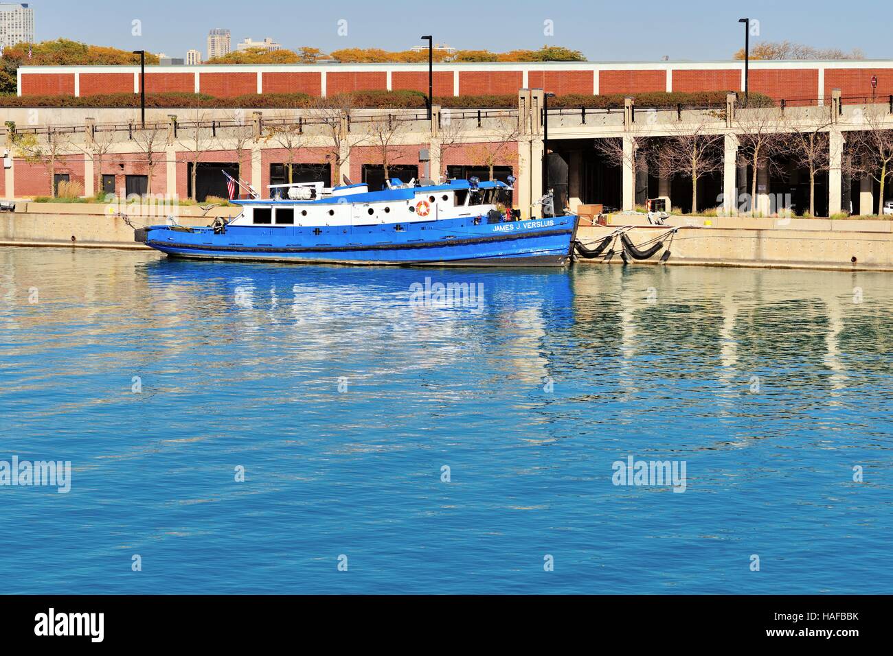 A lone ship is tied up in a Lake Michigan inlet channel across from ...