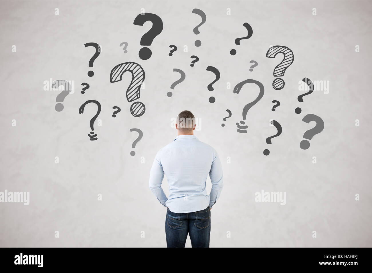 Backside of a young fit man with question marks around him, isolated in ...