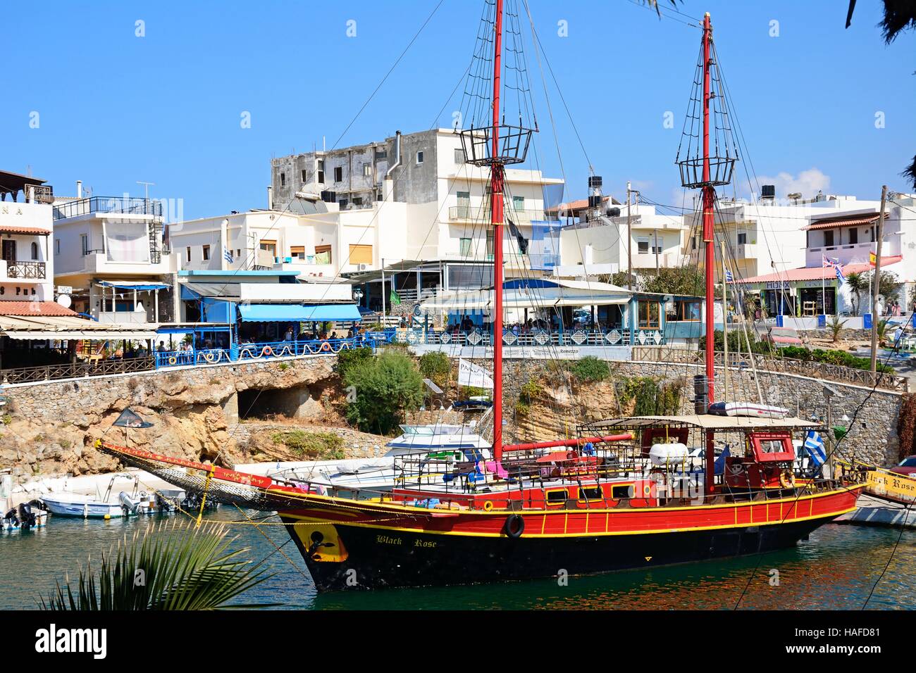 Black Rose Pirate ship moored in the harbour with waterfront ...
