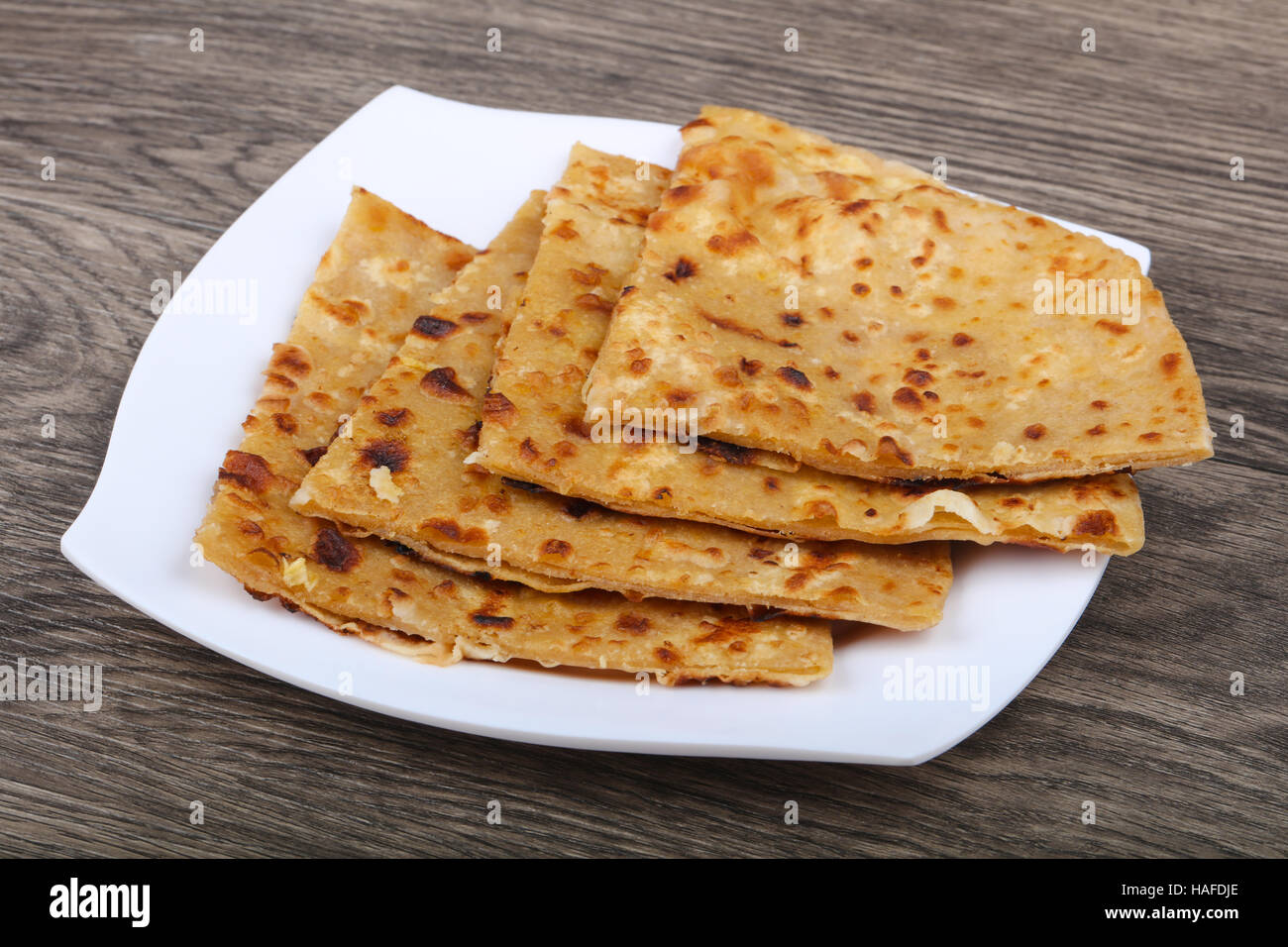 Indian bread roti on the plate in wood background Stock Photo - Alamy