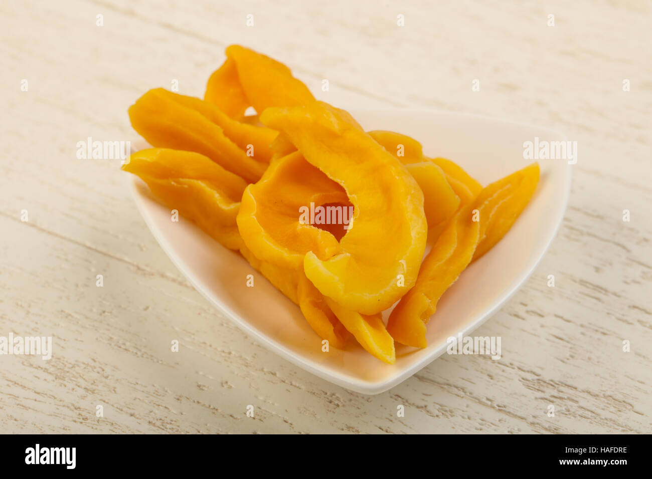 Dry mango chips heap in the bowl Stock Photo - Alamy
