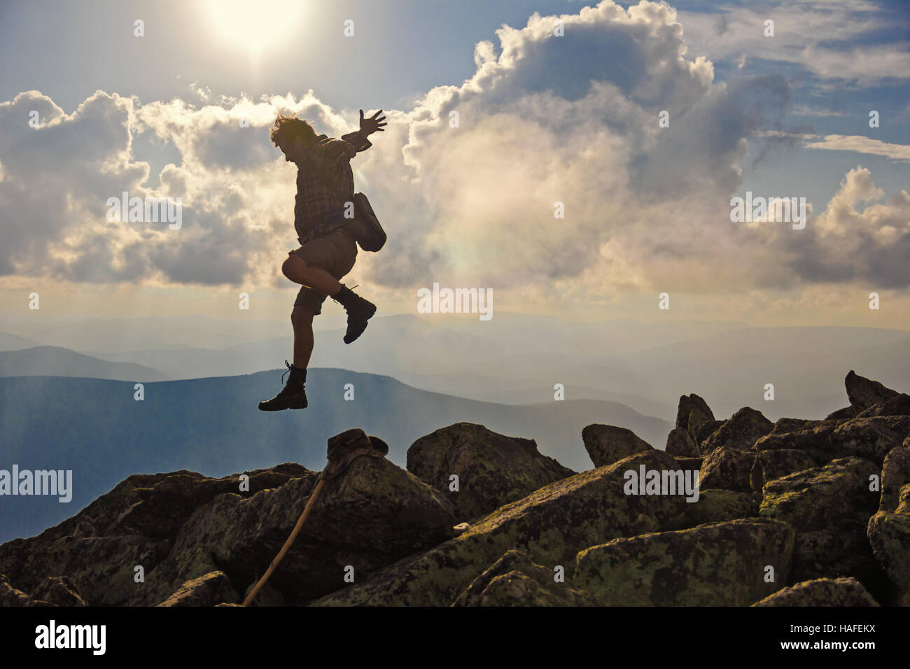 Silhouette man jumping over cliff hi-res stock photography and images ...