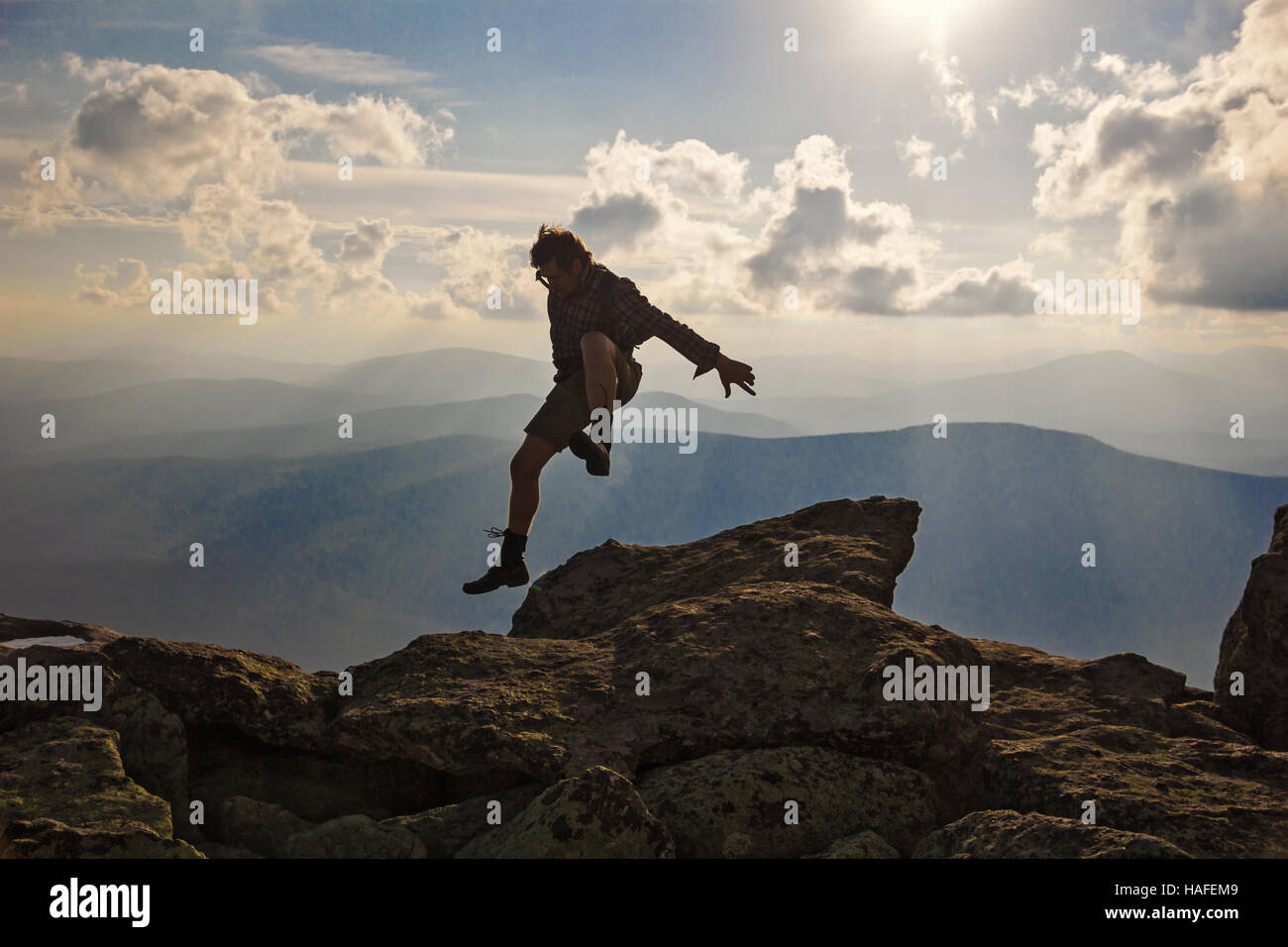 Silhouette man jumping over cliff hi-res stock photography and images ...