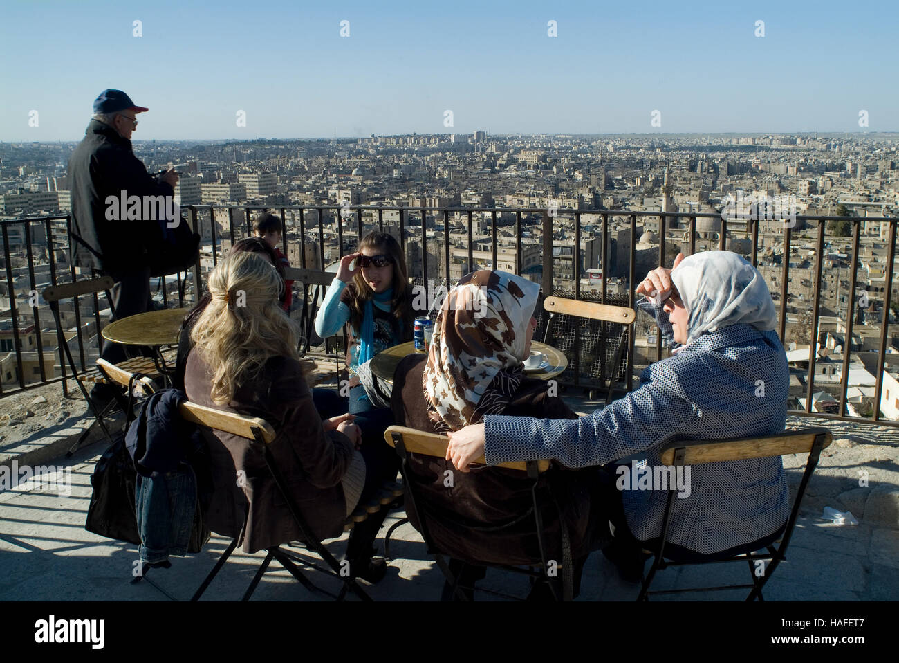 Tourists enjoy the view over Aleppo from the citadel, a large medieval ...