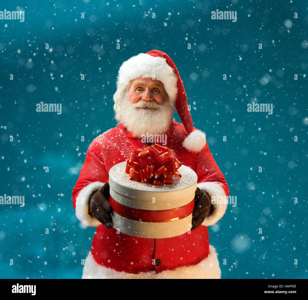Santa Claus in snowfall with gifts to children. Merry Christmas & New ...