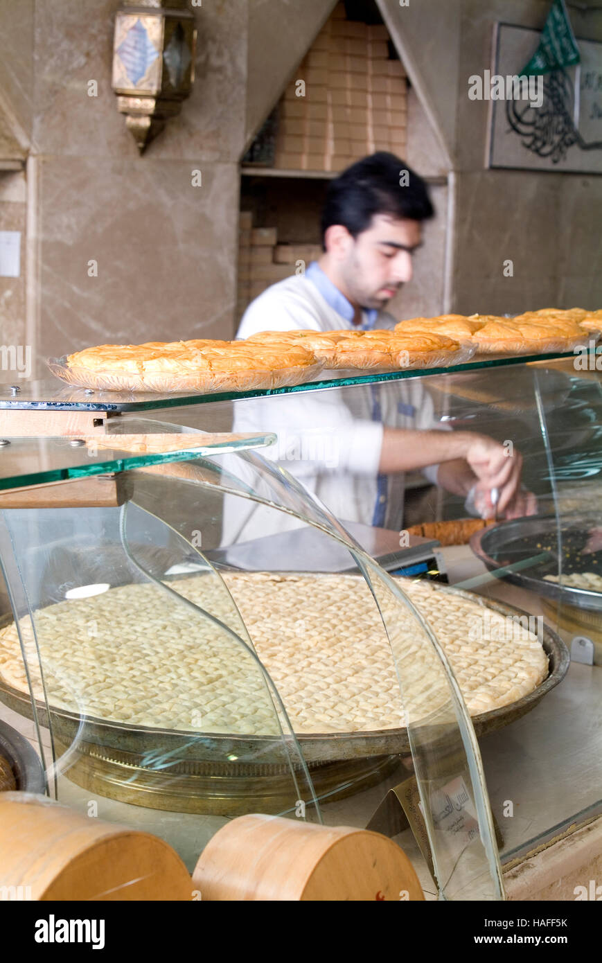 A cook at Al-Andalos Sweets in Aleppo in northern Syria preparing ...