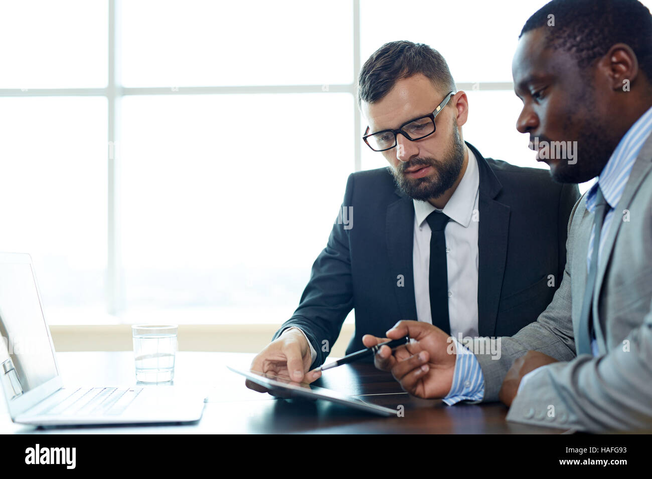 Businesspeople analyzing sales statistics hi-res stock photography and ...