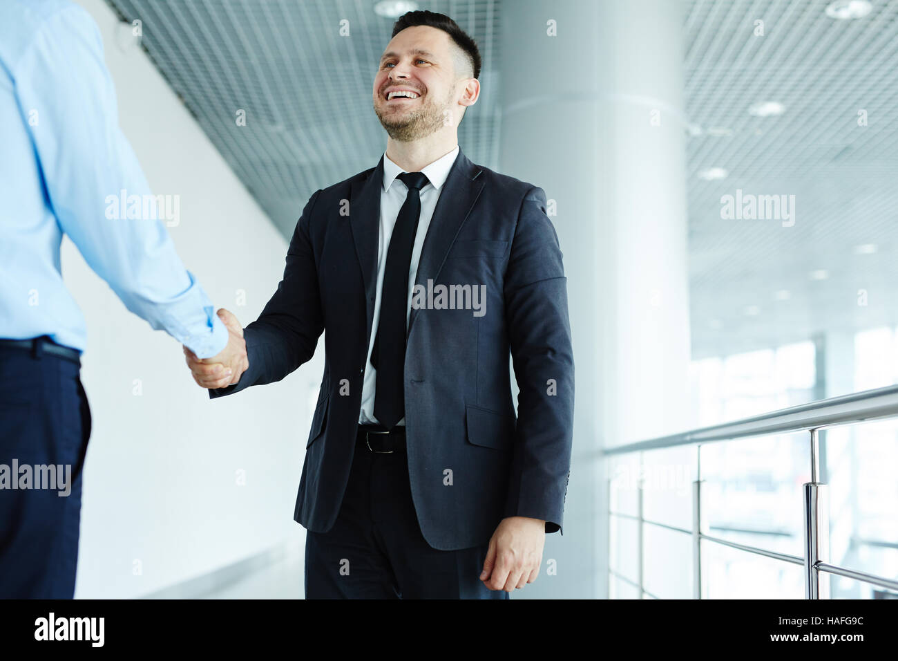 Happy business leader greeting new employee Stock Photo - Alamy