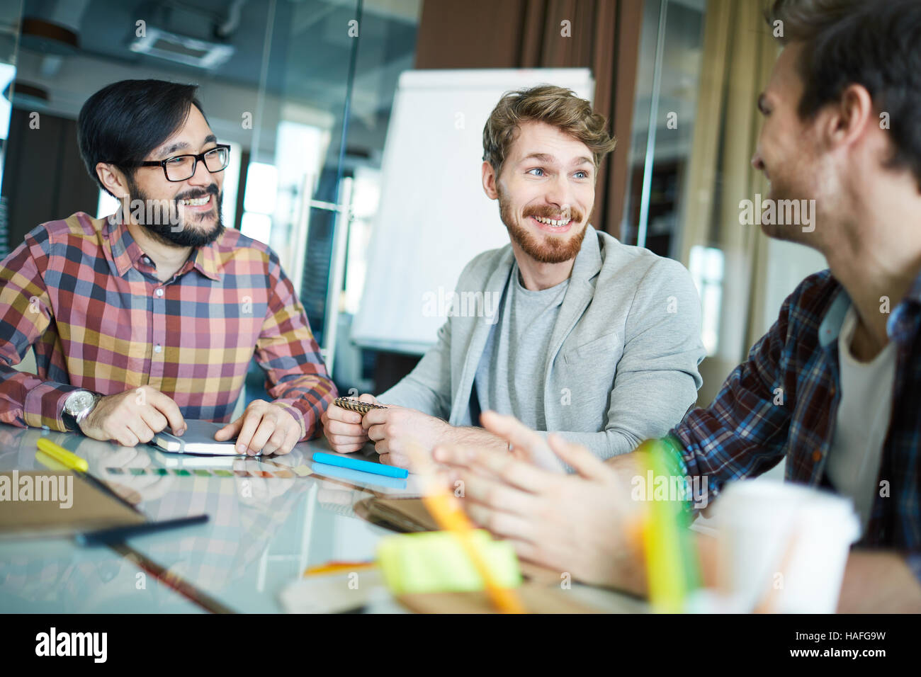 Team of young creative designers at work Stock Photo - Alamy