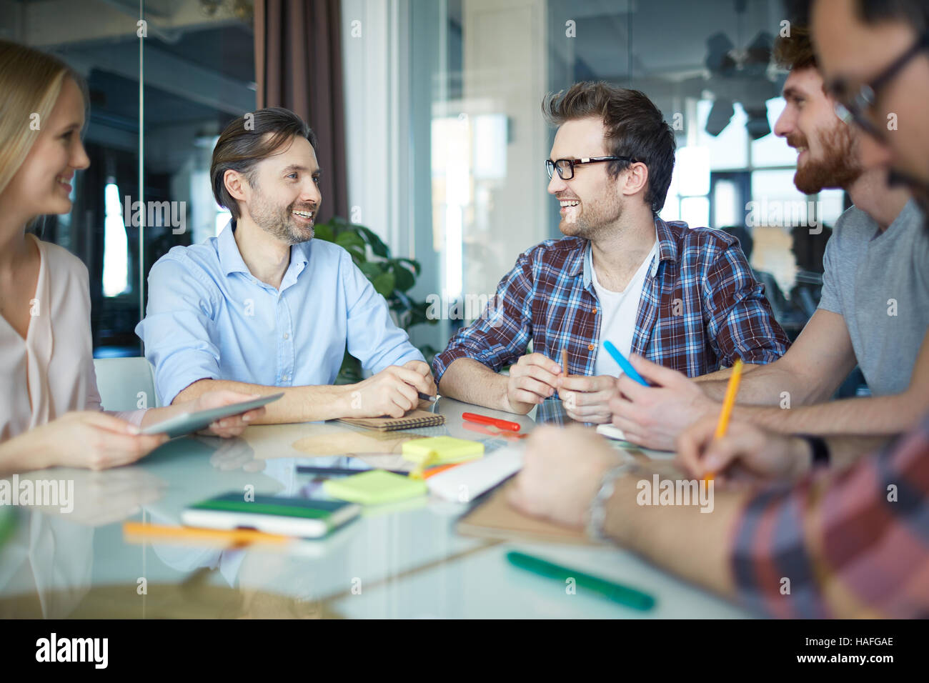 Team of contemporary designers sharing new ideas Stock Photo - Alamy