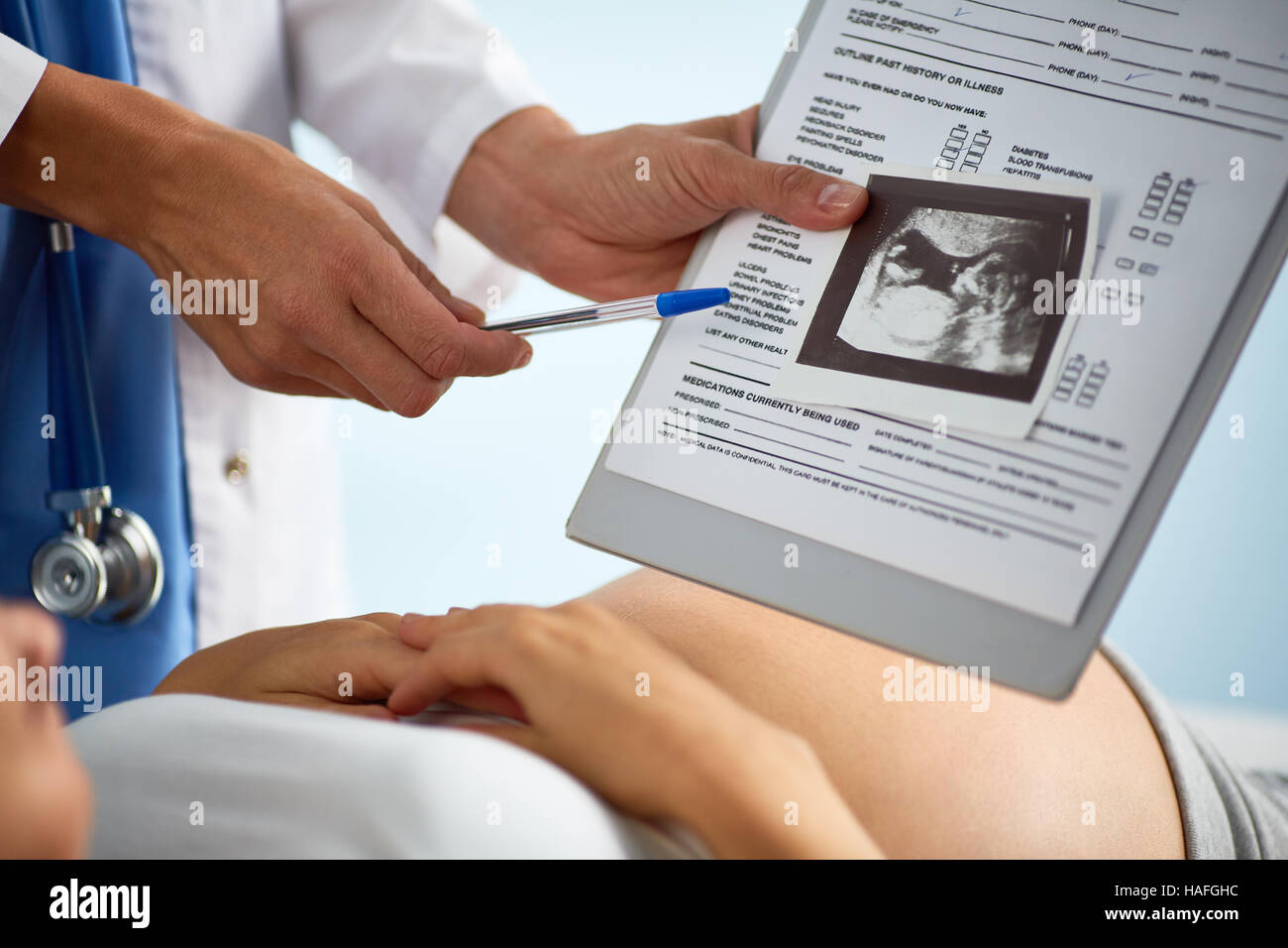 Sonogram of unborn baby in womb being shown and commented by doctor ...
