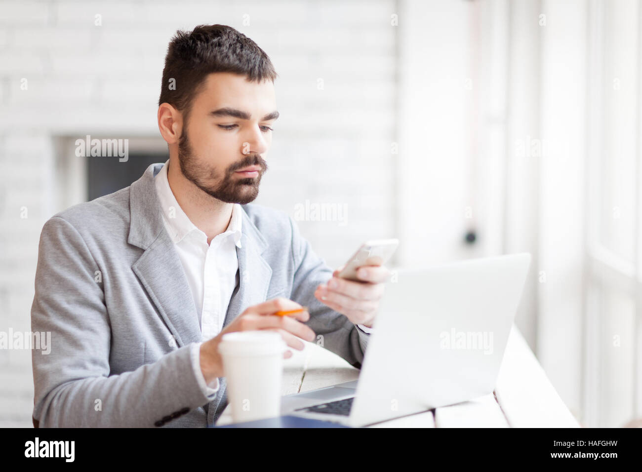 Young salesman or entrepreneur messaging in smartphone Stock Photo - Alamy