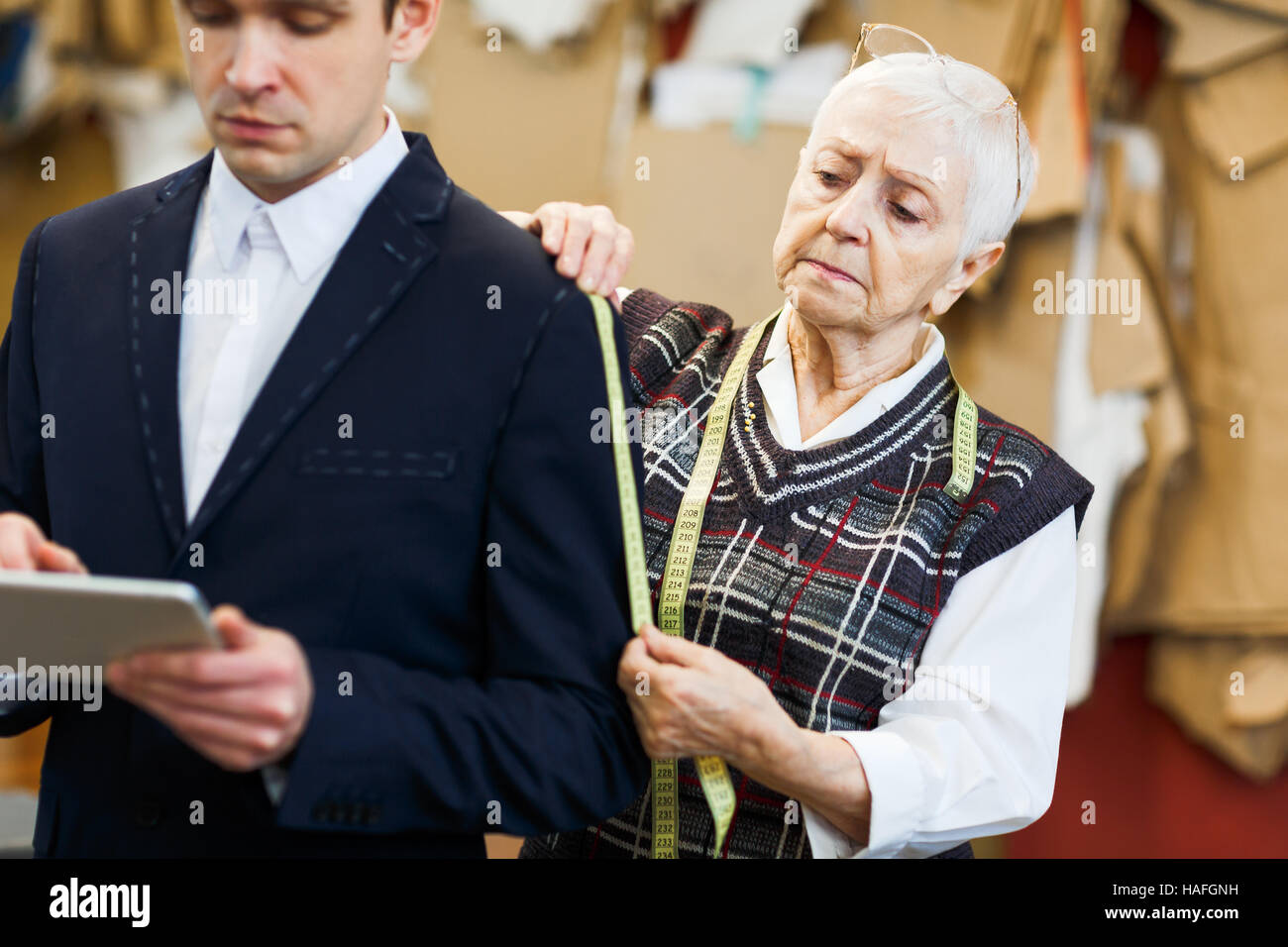 Tailor measuring jacket length hi-res stock photography and images - Alamy