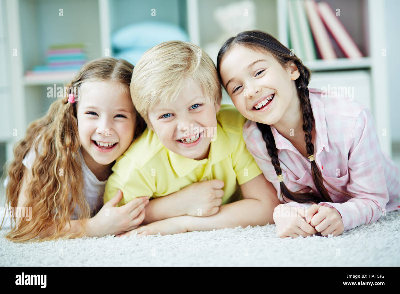 Adorable kids lying on the floor in kindergarten Stock Photo - Alamy