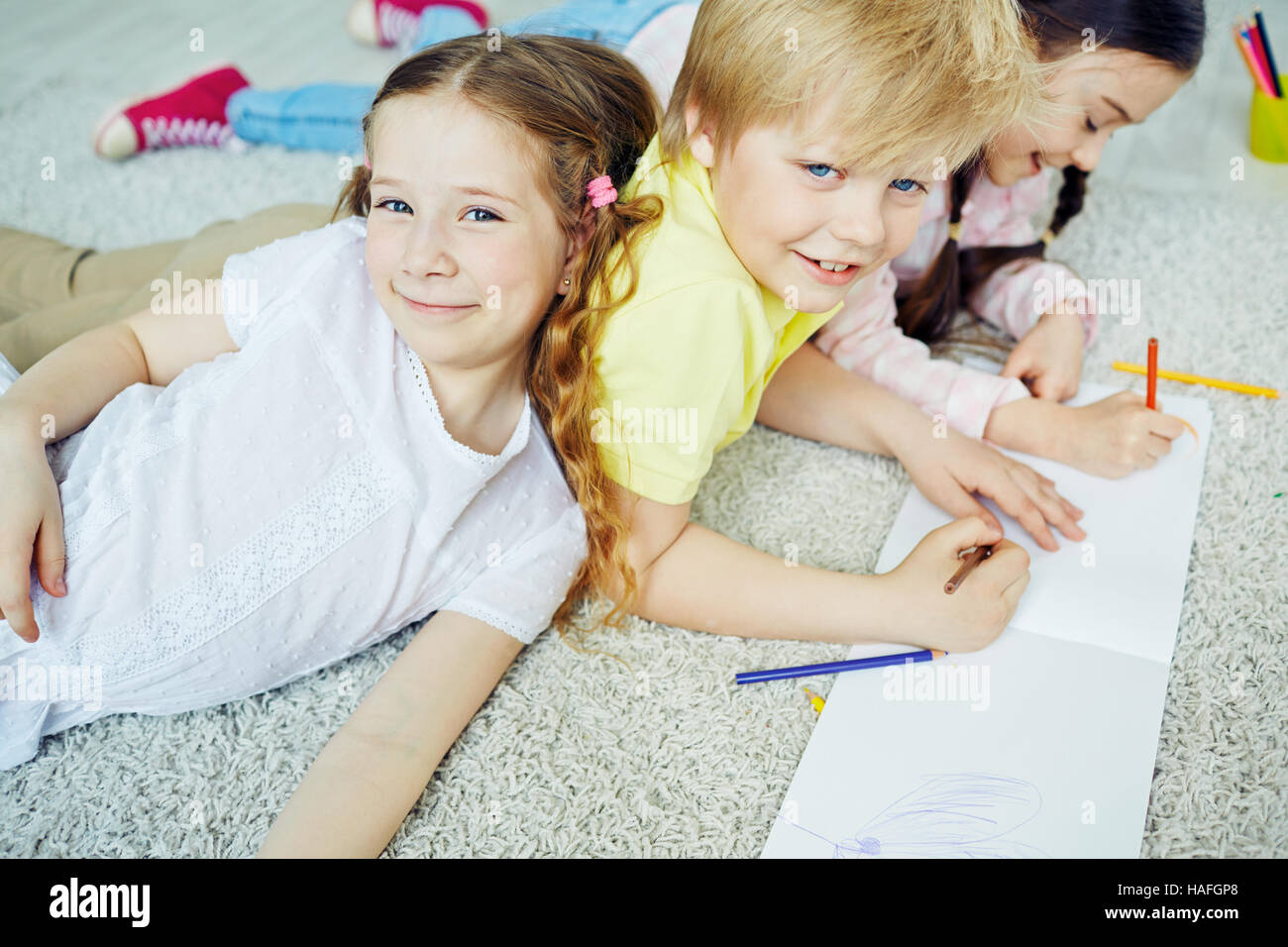 Relaxed children drawing in kindergarten Stock Photo - Alamy