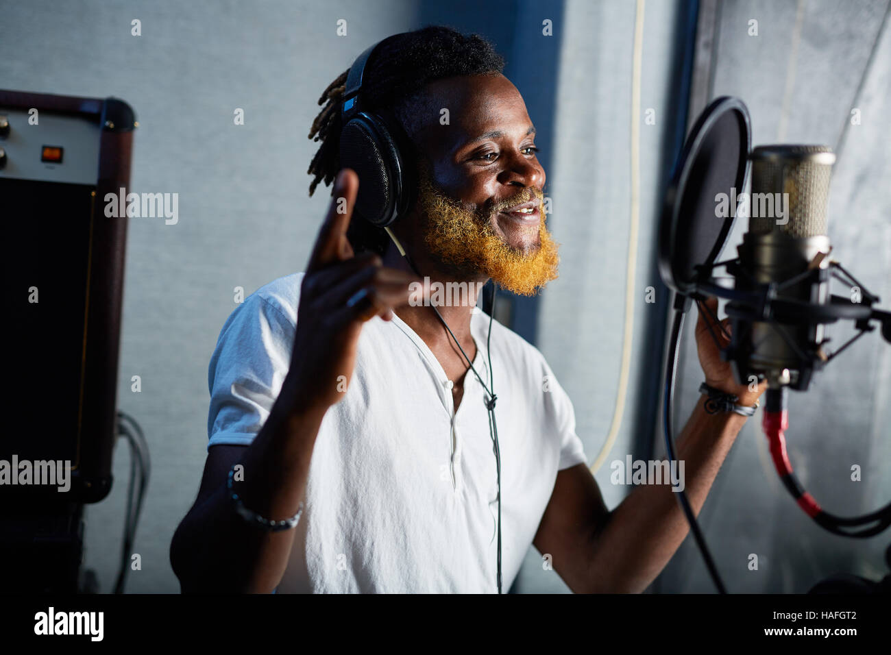 Enthusiastic singer performing and recording modern songs Stock Photo ...