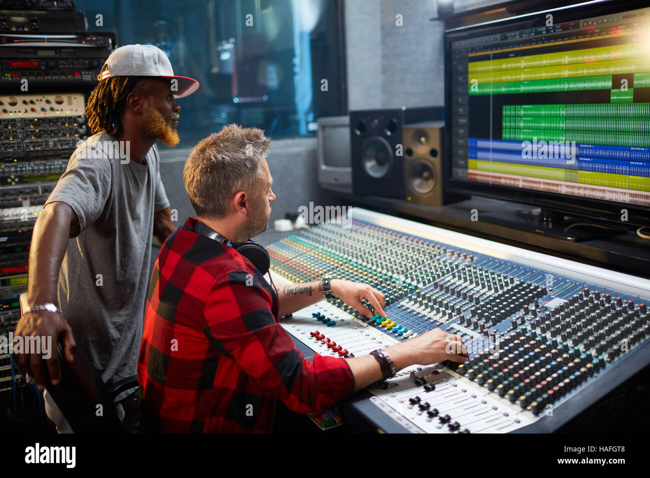 Two sound operators checking and adjusting frequency of sounds Stock ...