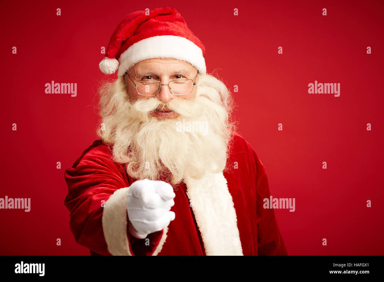 Smiling Santa with gloved hands pointing at you Stock Photo - Alamy