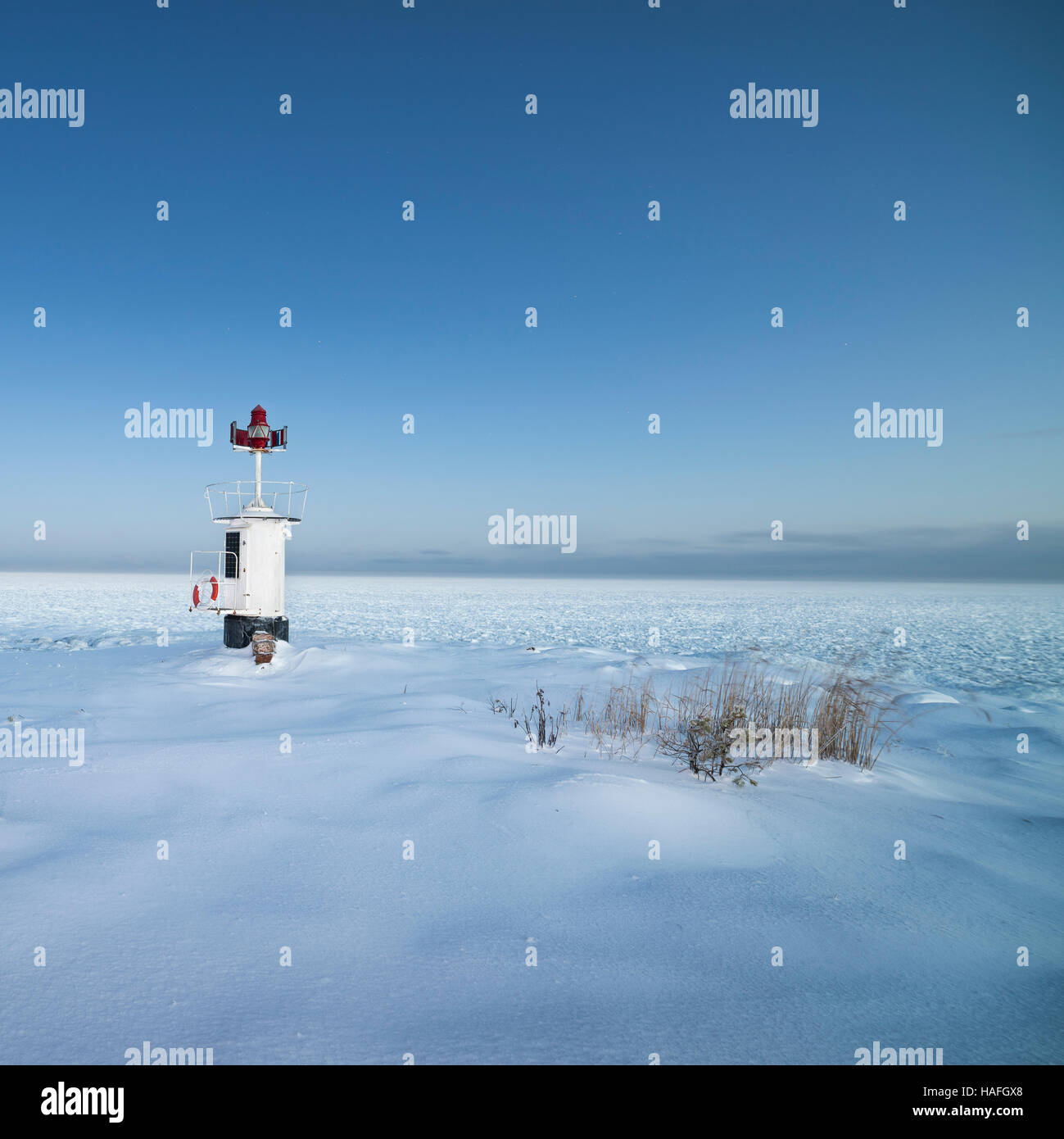 Small lighthouse in the snow at the coast of Roslagen, Uppland on a ...