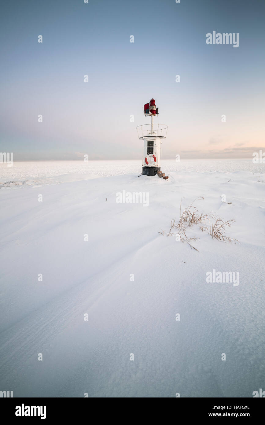 Small lighthouse in the snow at the coast of Roslagen, Uppland on a ...