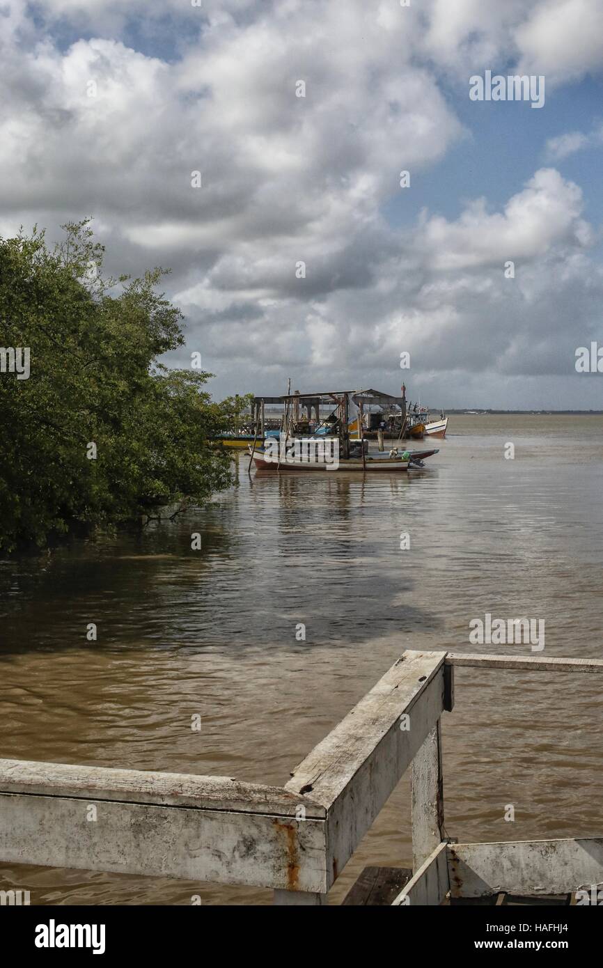 Suriname river with boats near the shore Stock Photo - Alamy