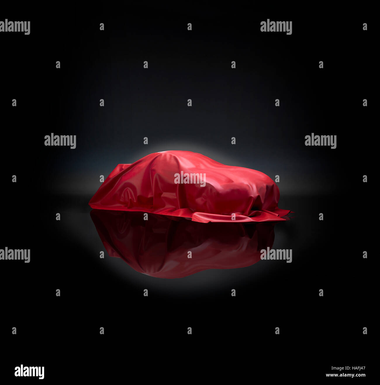 New concept Car draped with red cloth ready for the reveal on stage set ...