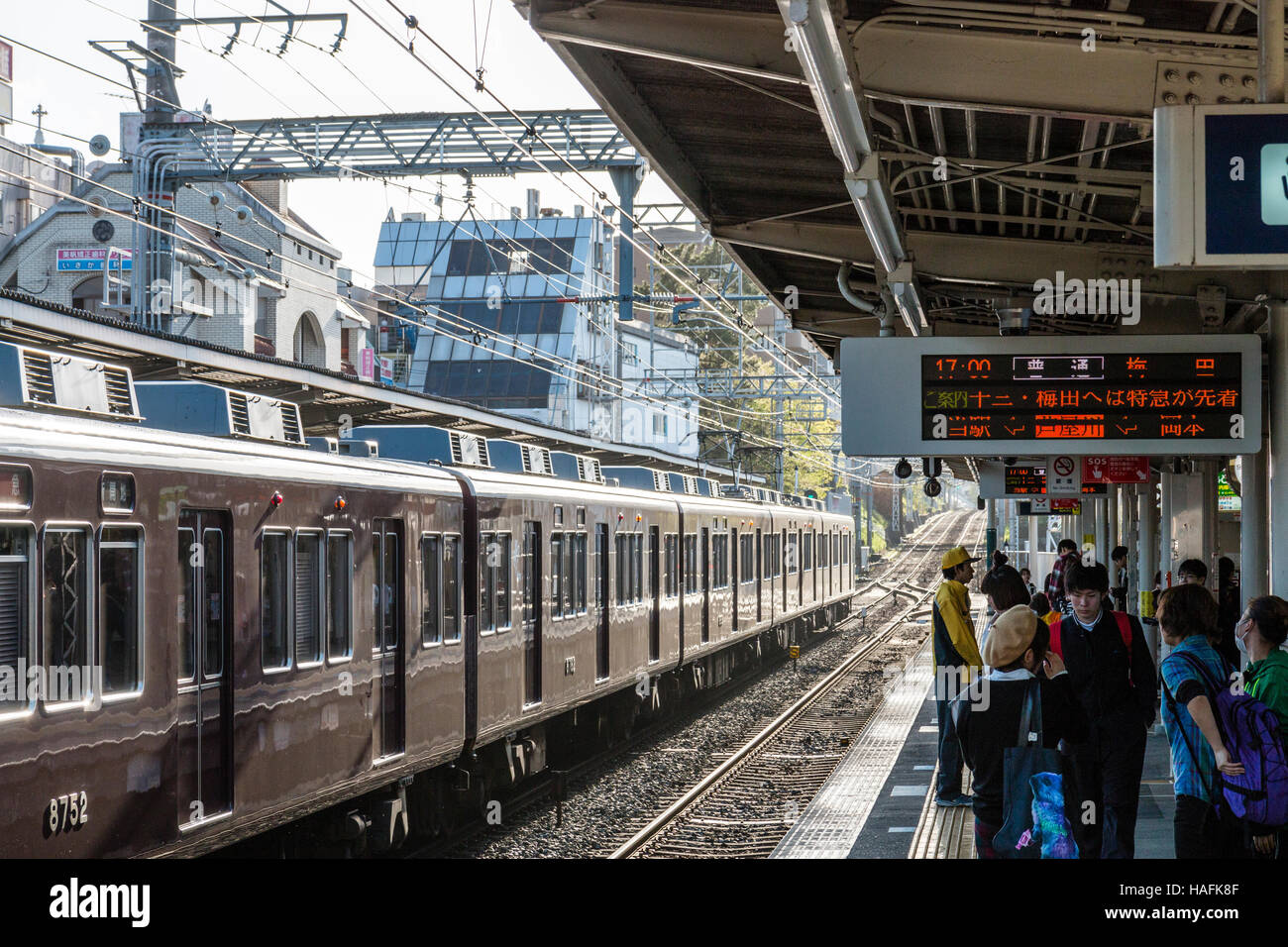 Japan, Shukugawa. Hankyu station. People waiting for next train on ...