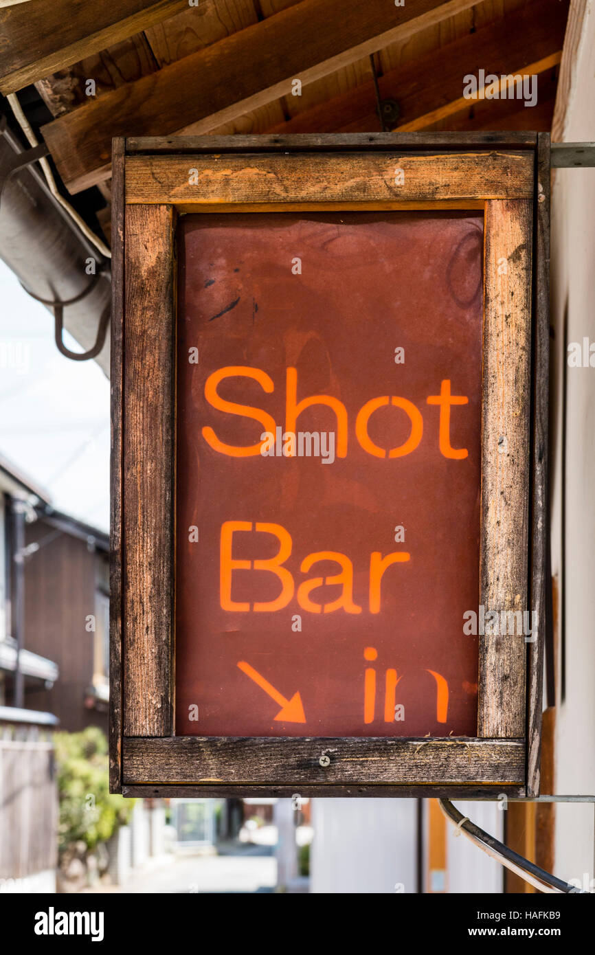 Japan, Tatsuno. Old rusty coloured sign on side of Japanese bar, "Shot ...