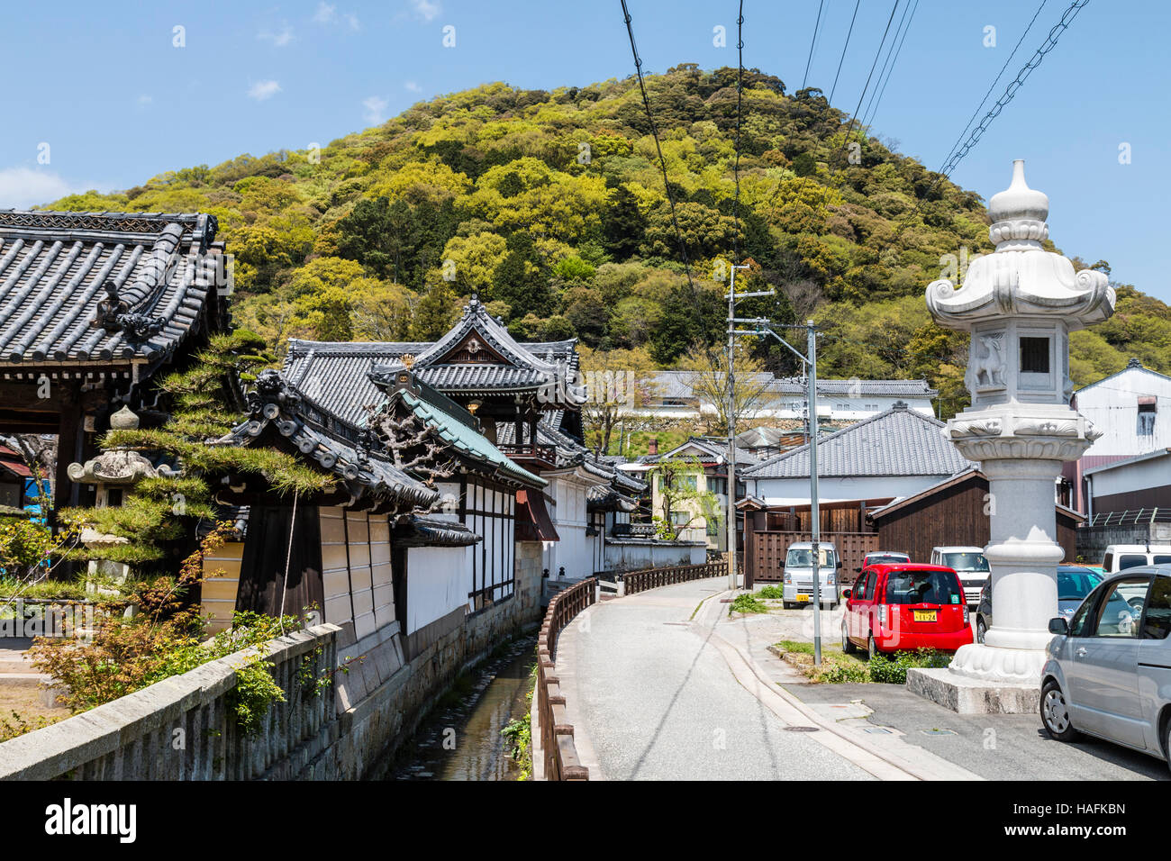 Japan, rural town of Tatsuno. View along road with small stream running ...