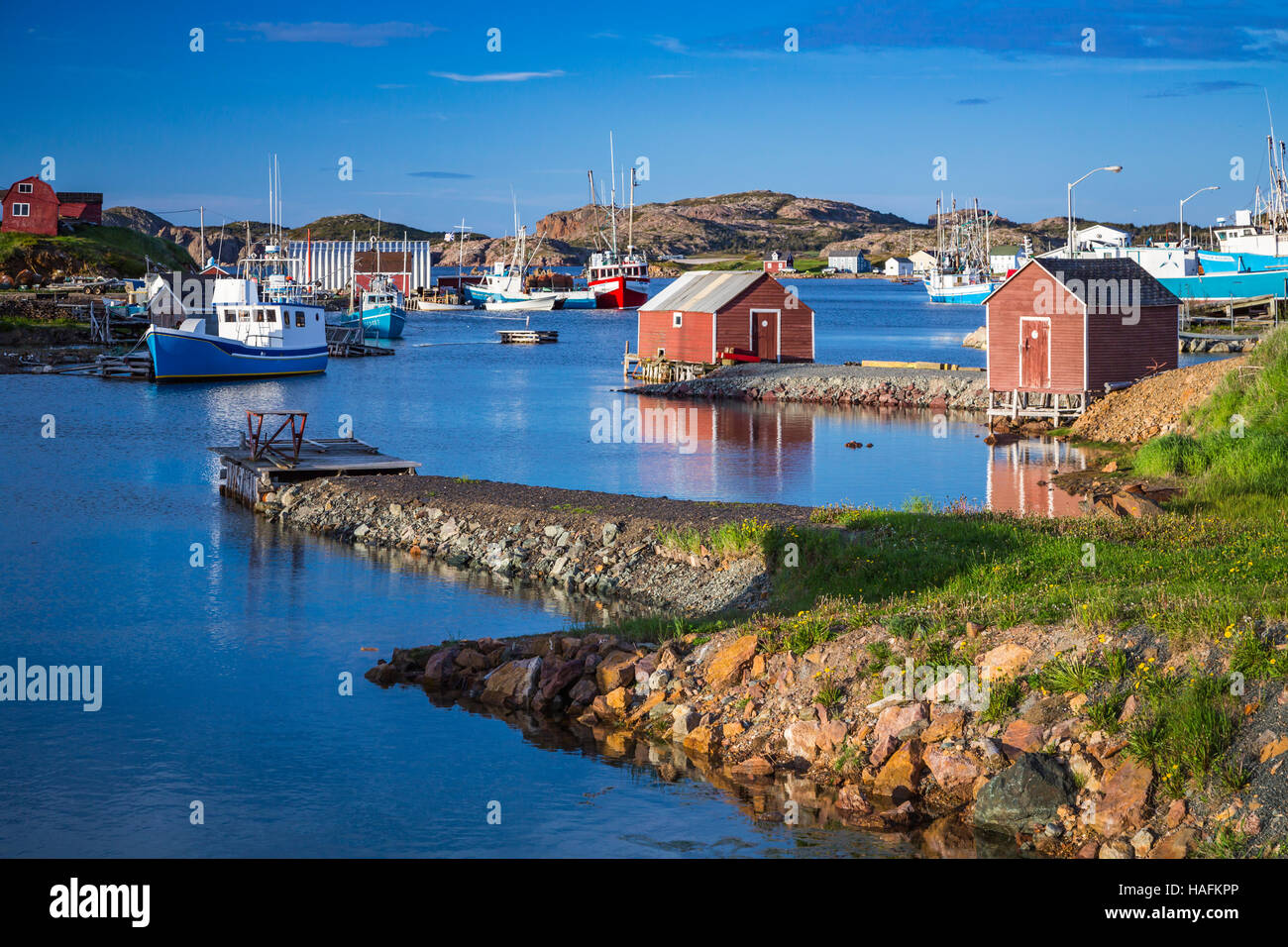 Reflections of fishing stages and boats near Twillingate, Newfoundland ...