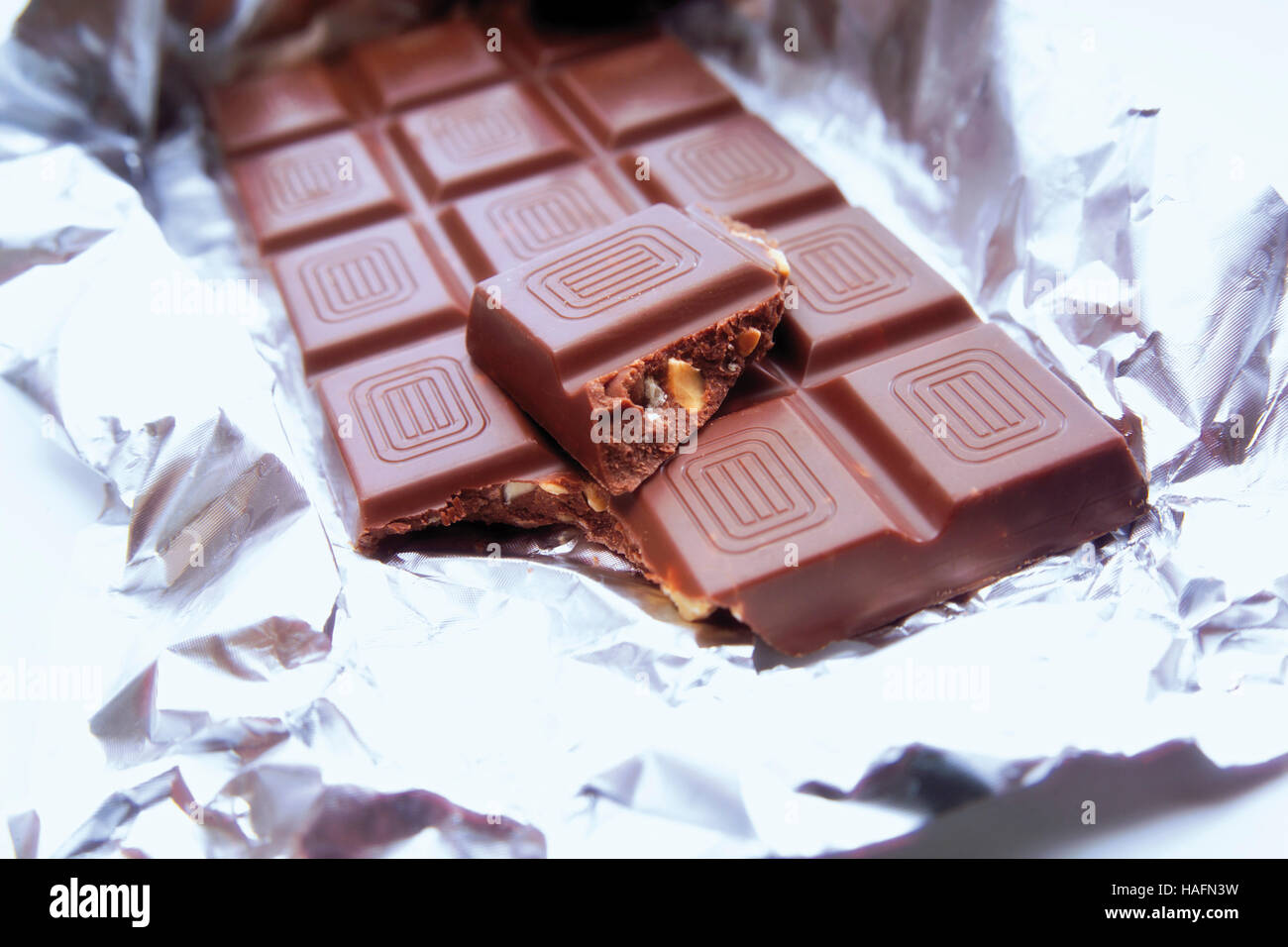 Bar of chocolate in silver paper Stock Photo - Alamy