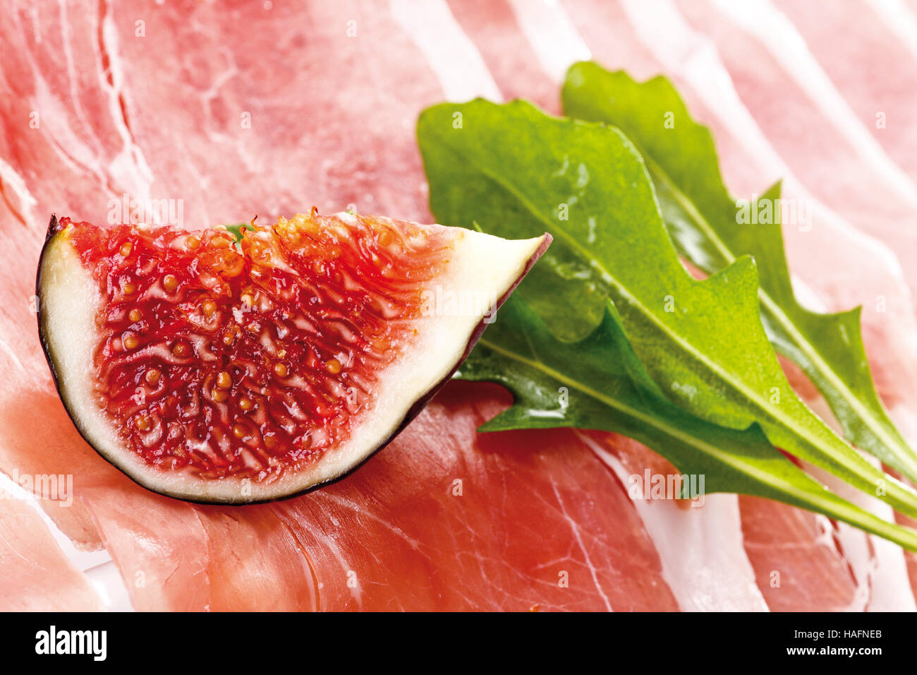 Fresh Fig (Ficus carica) with raw ham and rucola Stock Photo - Alamy