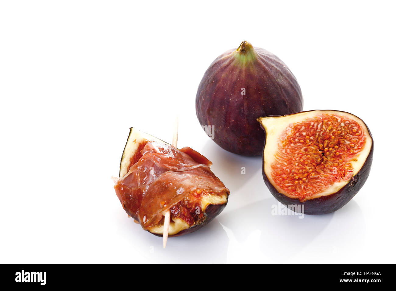 Fried fig topped with raw ham Stock Photo - Alamy
