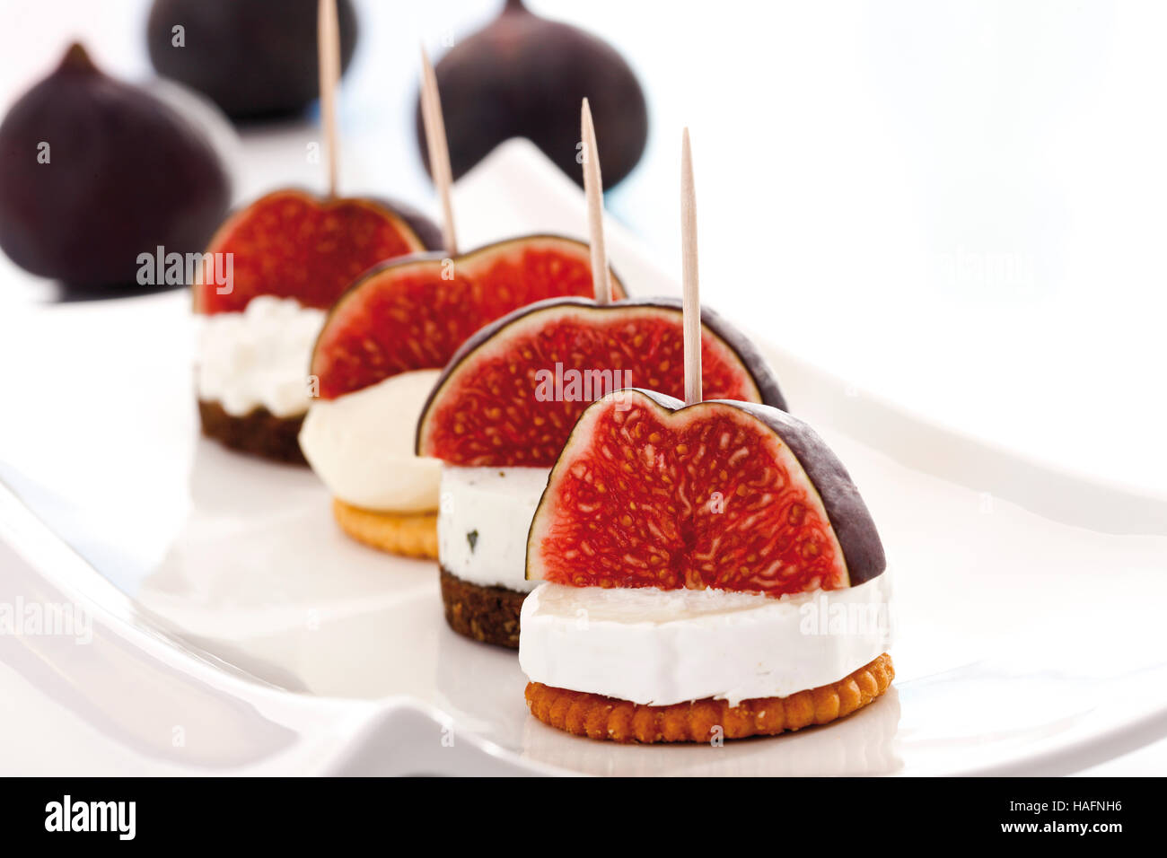 Finger food, crackers and pumpernickel topped with assorted cheese and ...