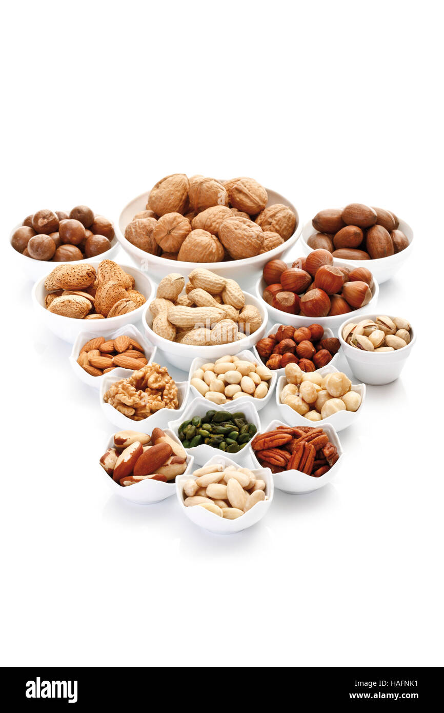 Assorted nuts and kernels in ceramic bowls, pecans, walnuts, hazelnuts ...