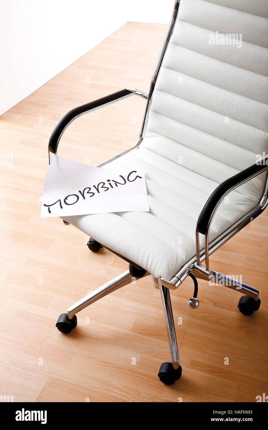 Mobbing or Bullying or Workplace Harassment sign on an office chair ...