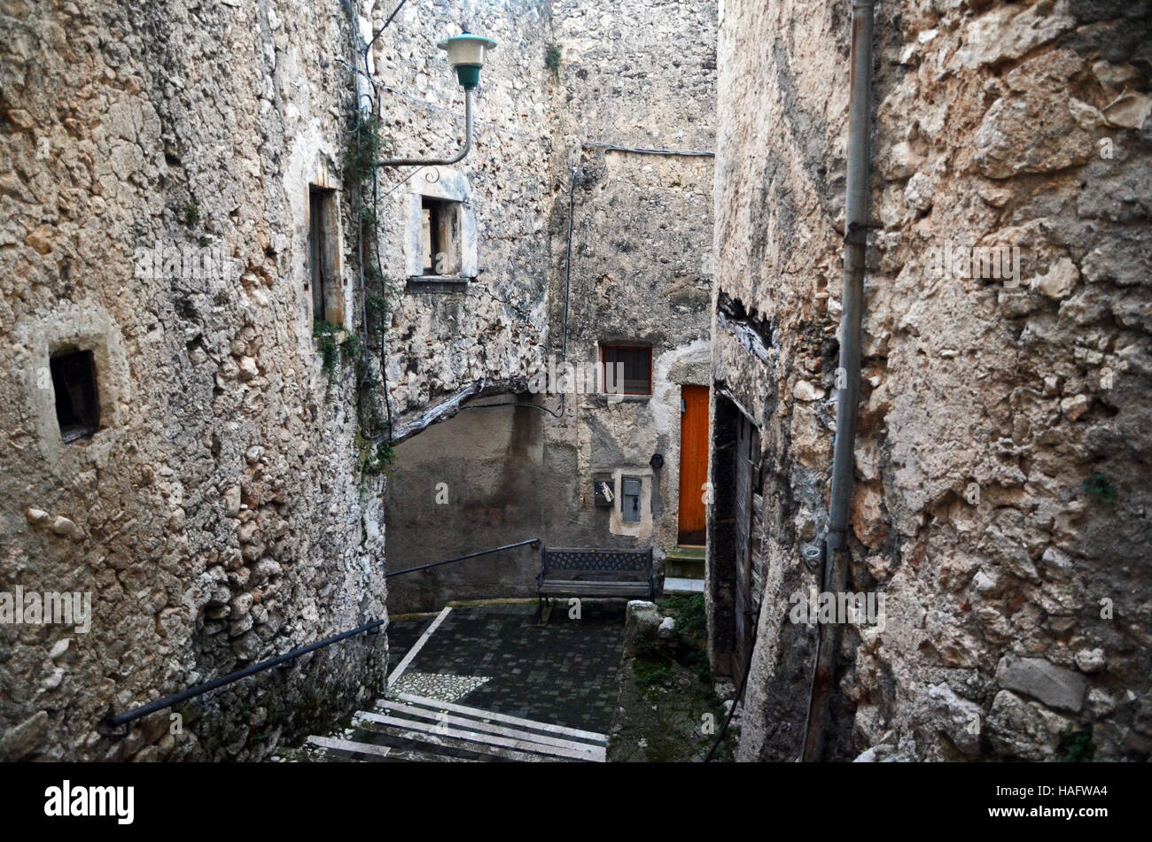 Narrow alley between old stone buildings, Roccacasale, L'Aquila ...